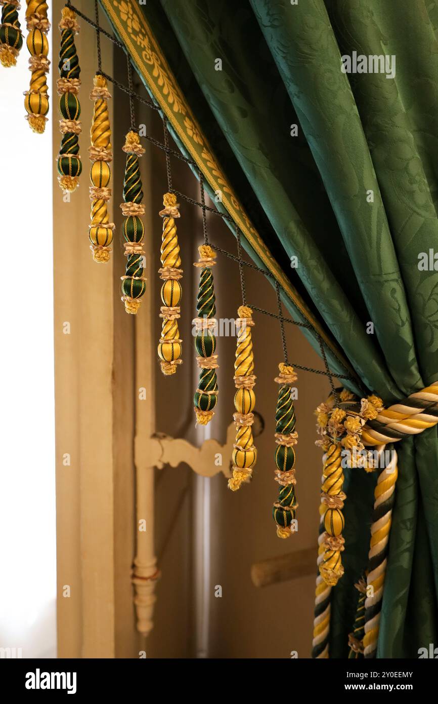 Beautiful green curtain with tassel trim fringe Stock Photo - Alamy