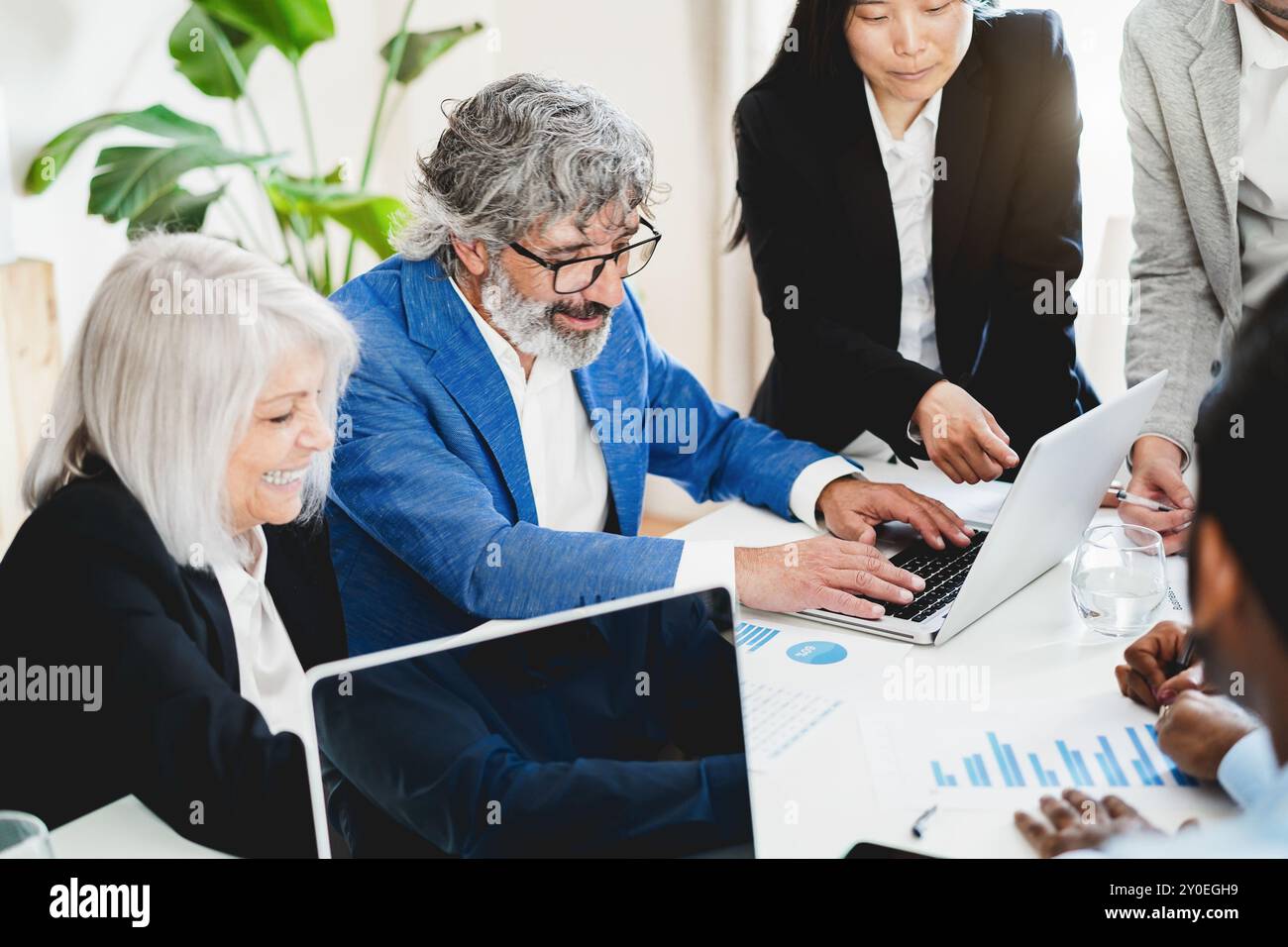 Multigenerational business people working inside corporate office ...