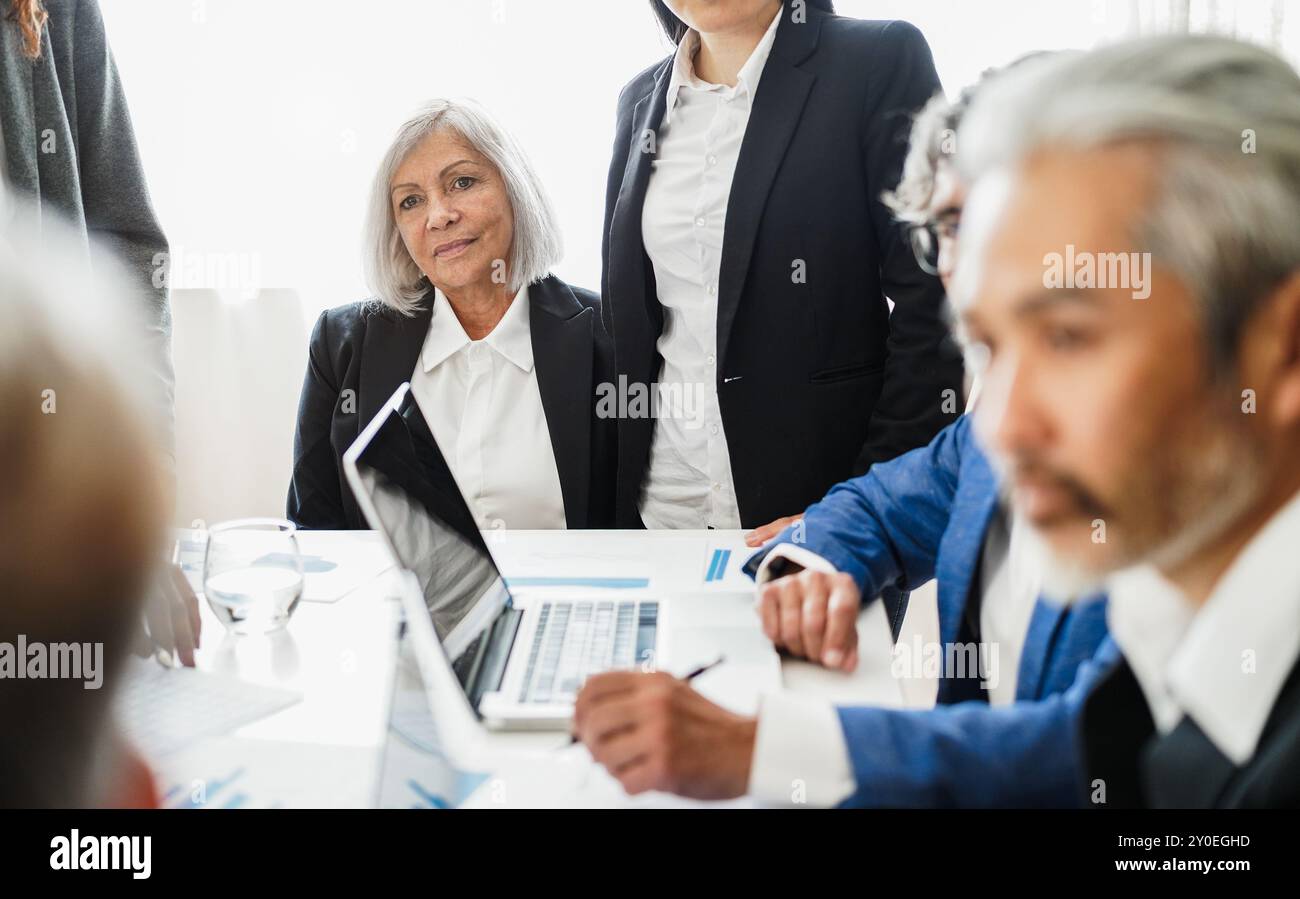 Multigenerational business people working inside corporate office ...