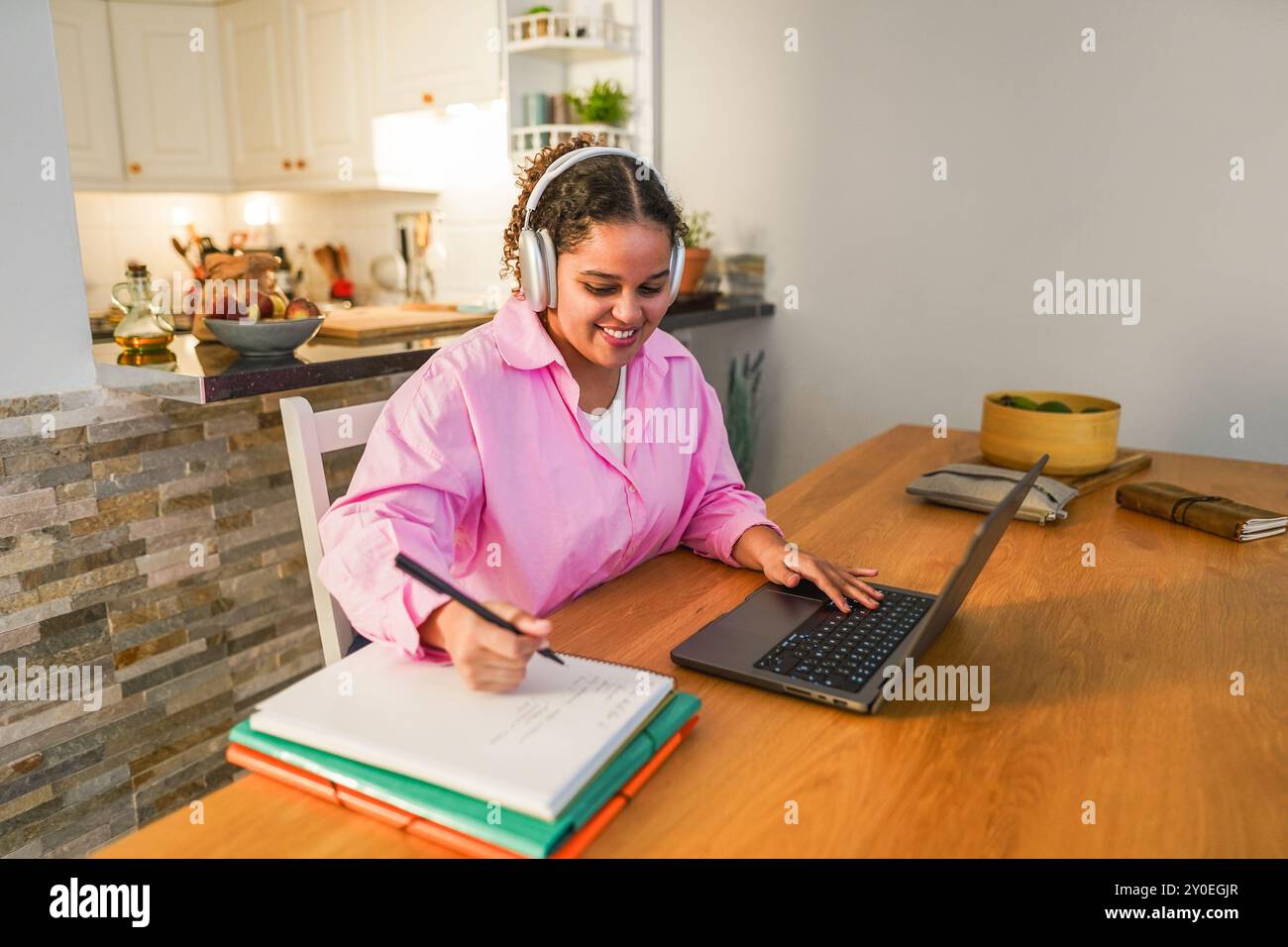 African girl using laptop computer from home while studying at college ...