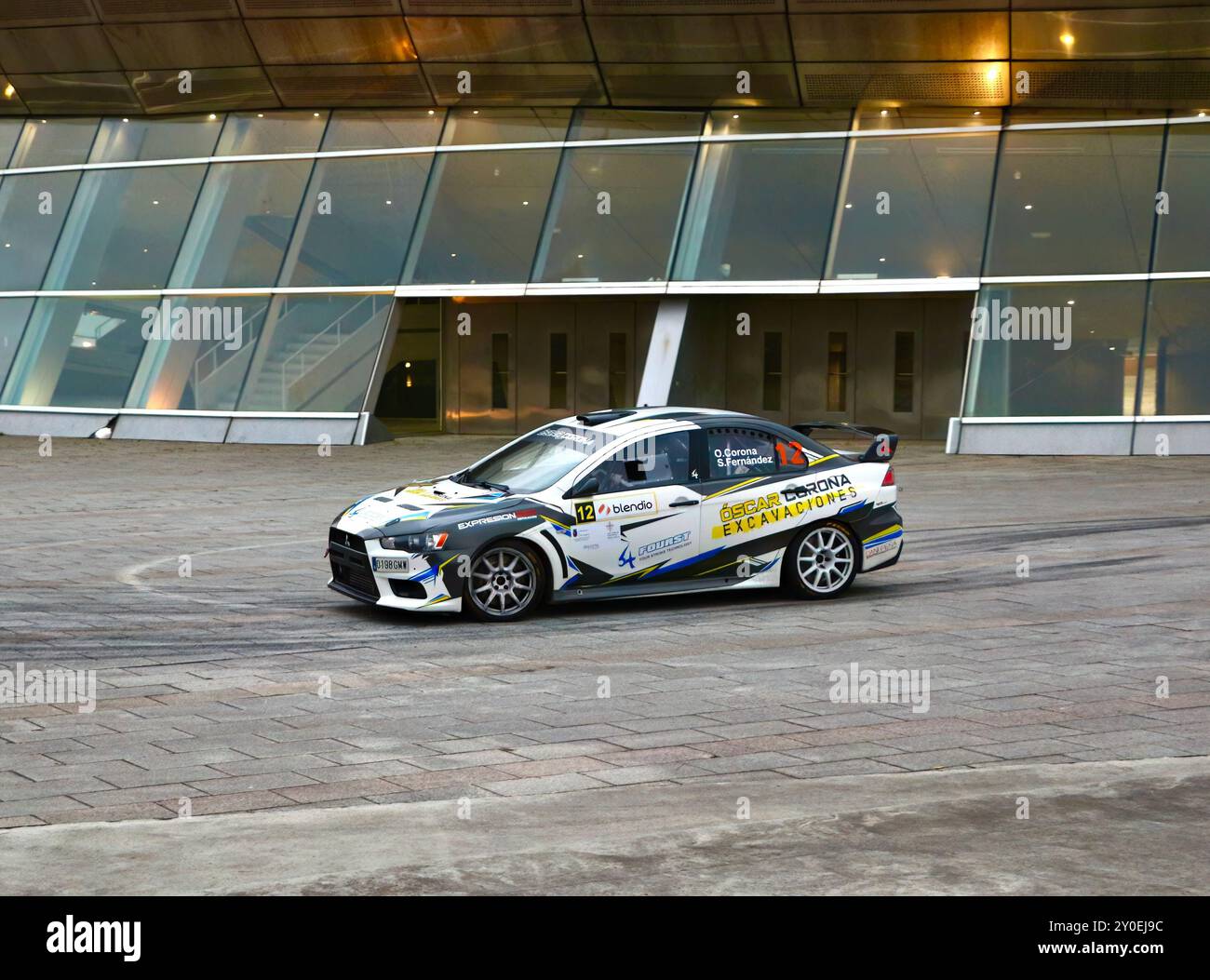 Oscar Corona Herrera driving a Mitsubishi Lancer Evo X rally car in the ...