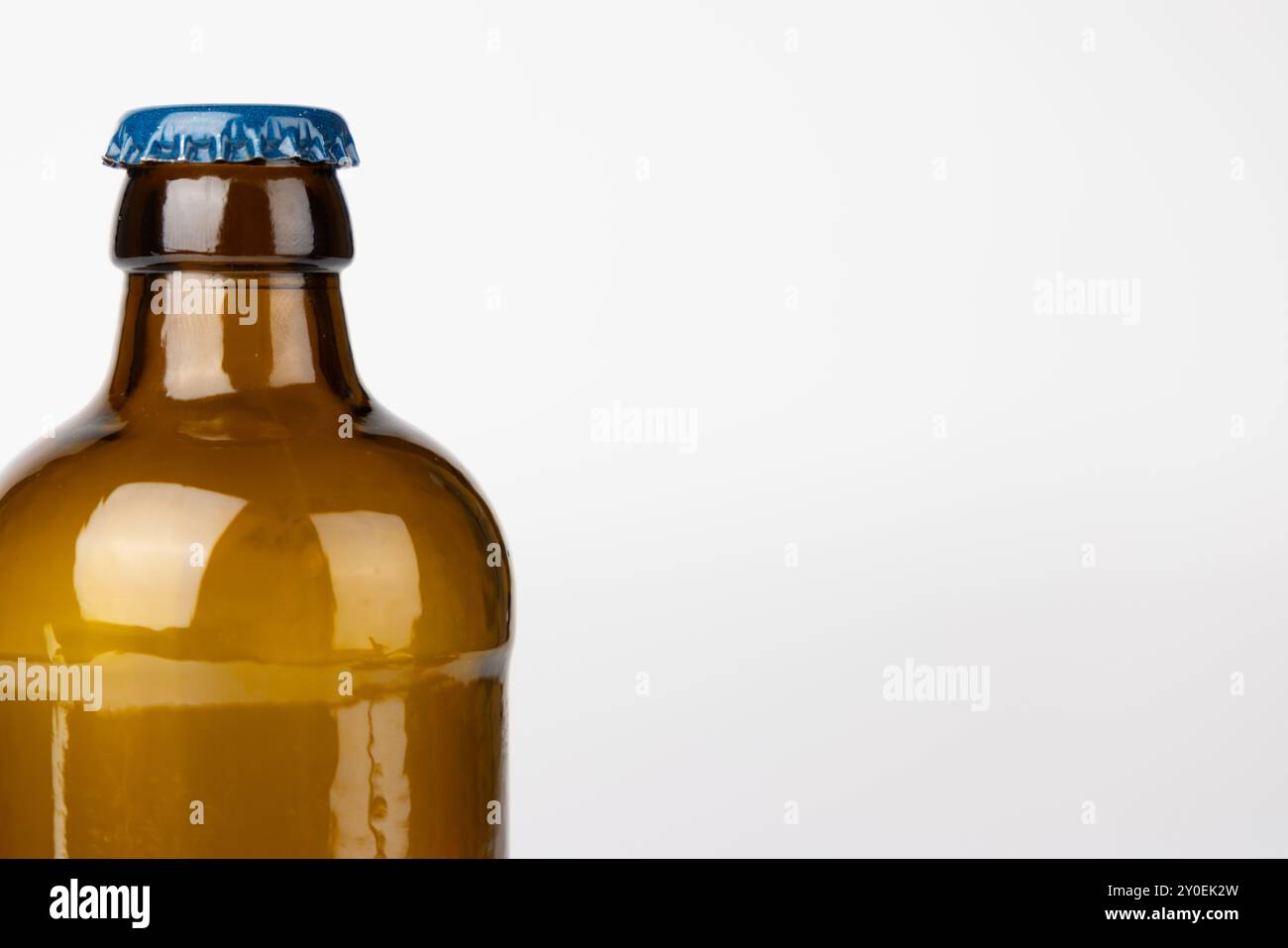 The upper part of a brown beer bottle is centered on the left side ...