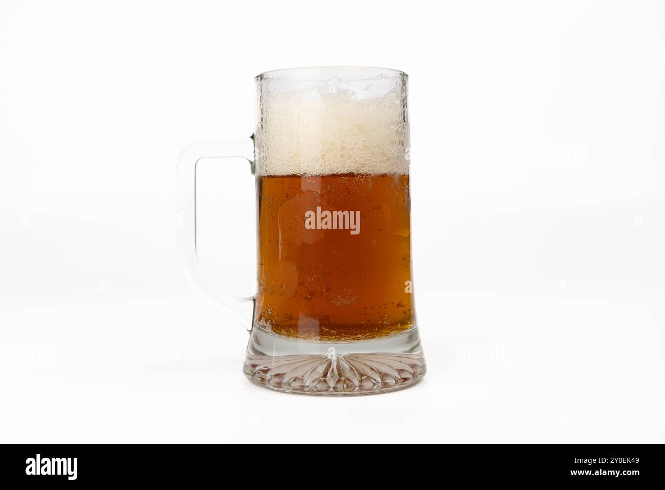 A horizontal photo showing a frosty glass jug filled with toasted beer ...