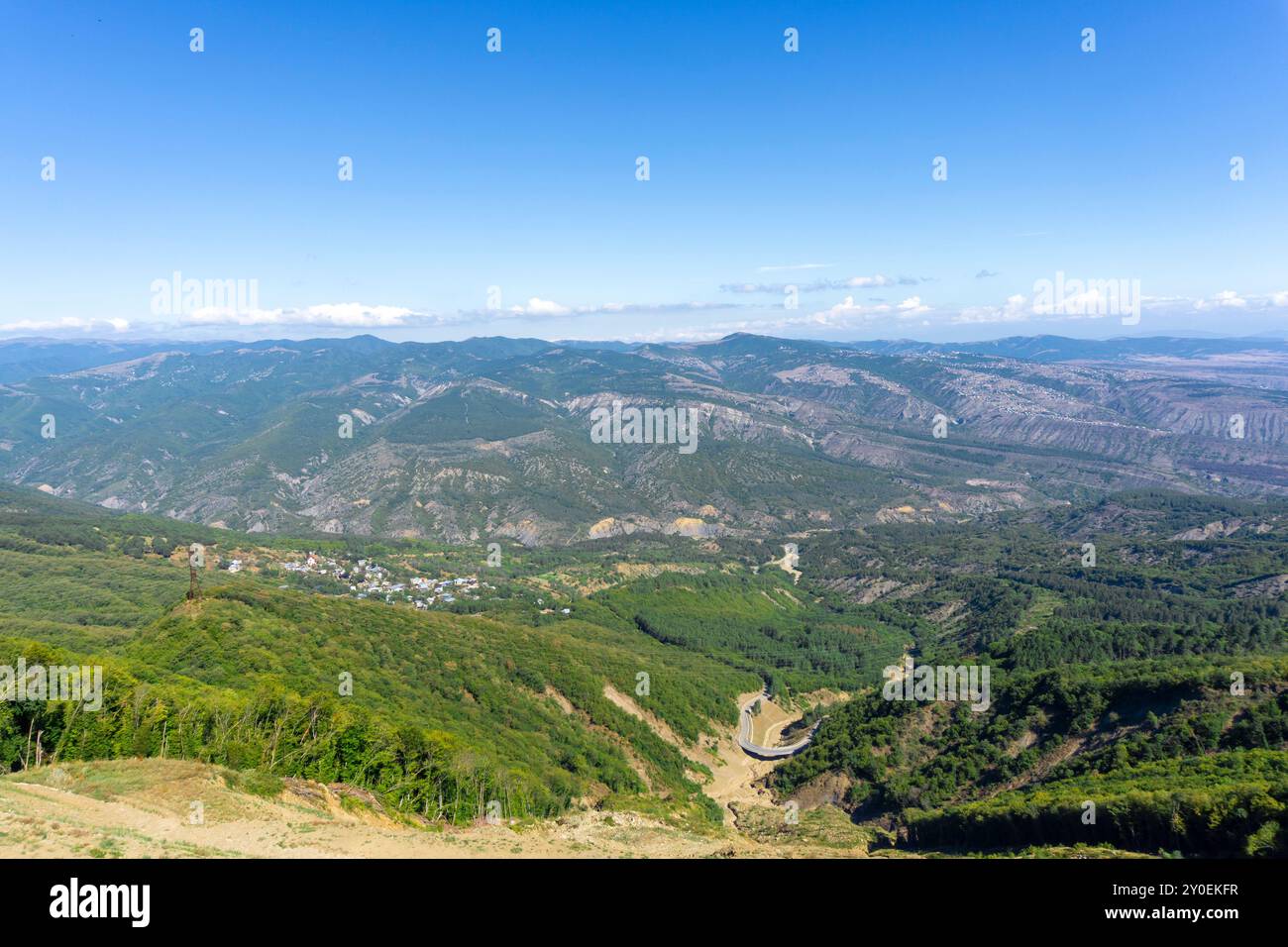 A curved road bridge at the bottom of an abyss, a village on a slope ...