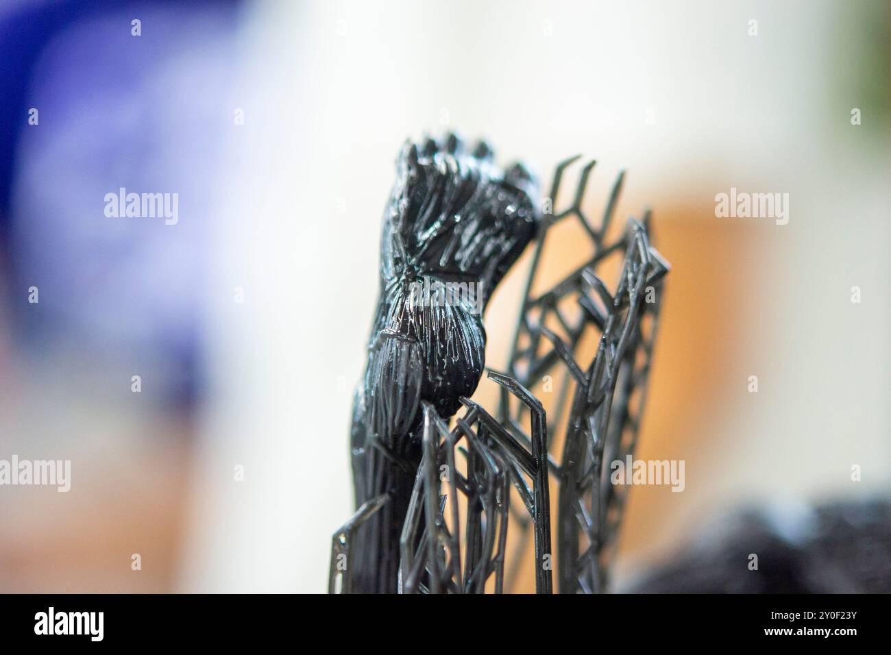 Model of leg printed on a 3D printer from black rubber, close-up. Part ...