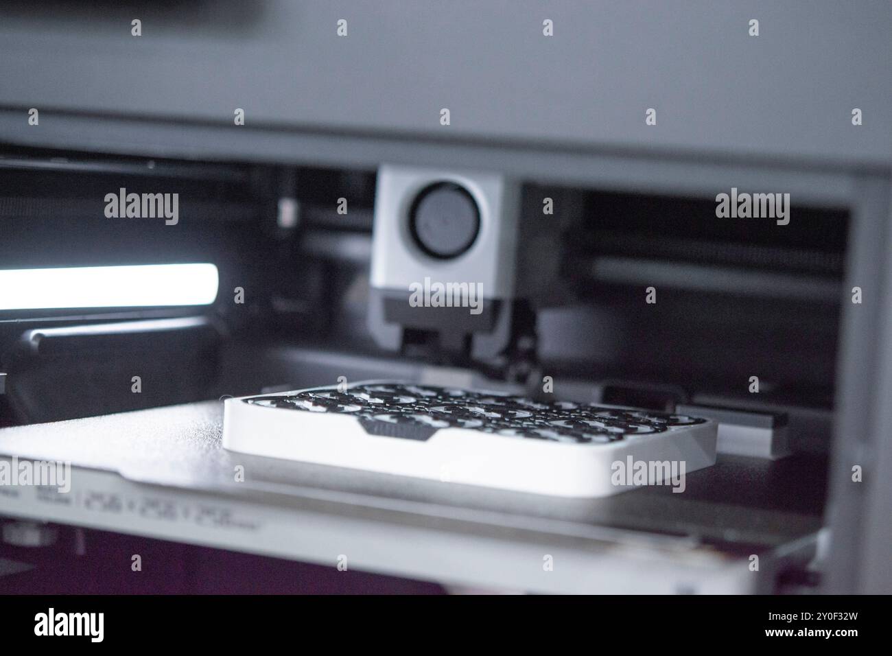 3D printer close up. A working 3D printer in process of printing object ...