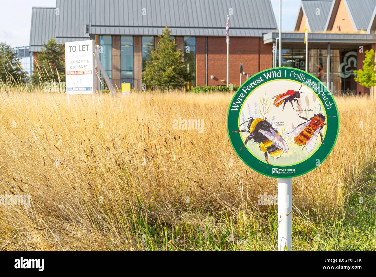 Large circular sign showing a bee pollinator patch outside council ...