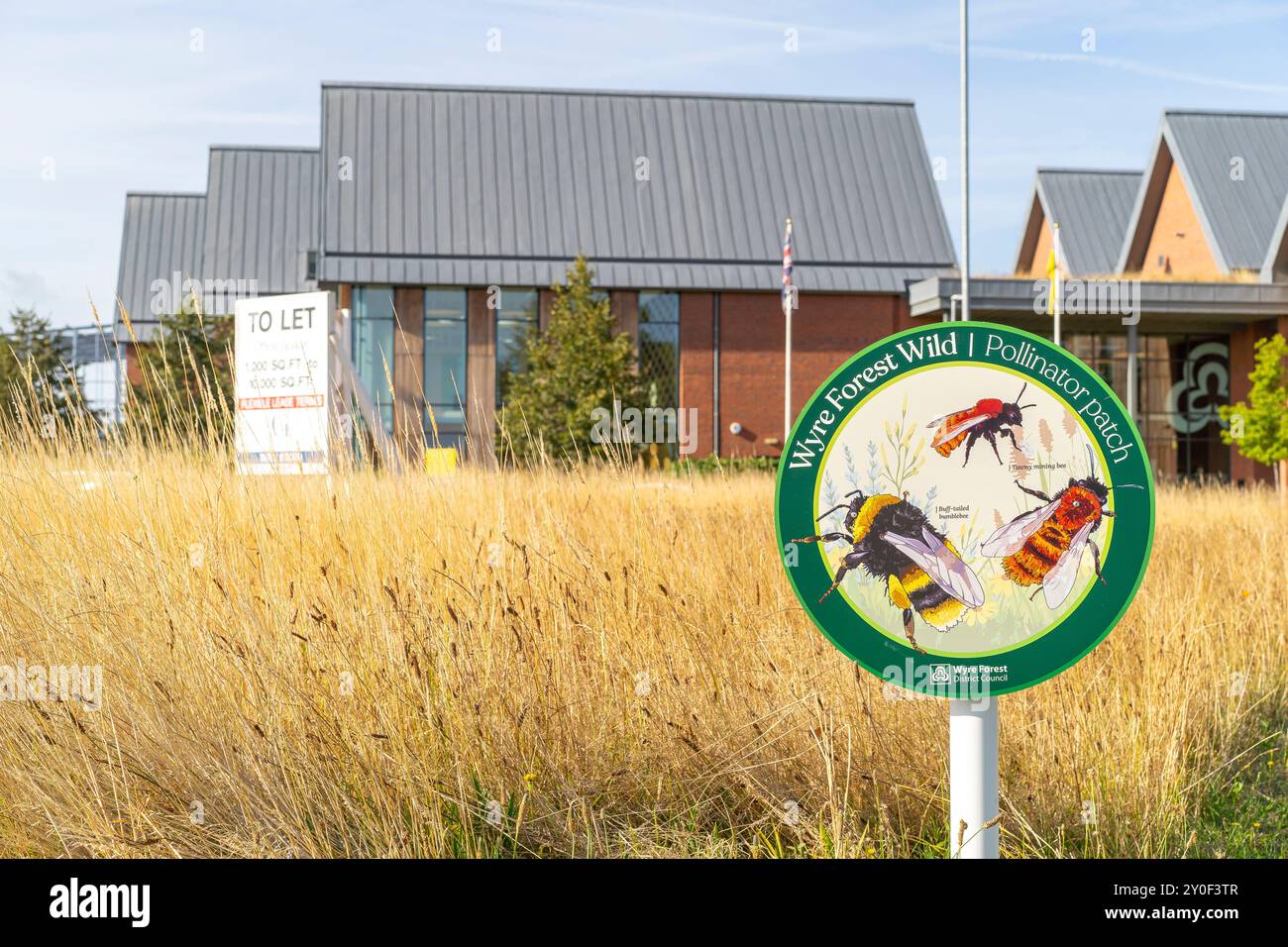 Large circular sign showing a bee pollinator patch outside council ...