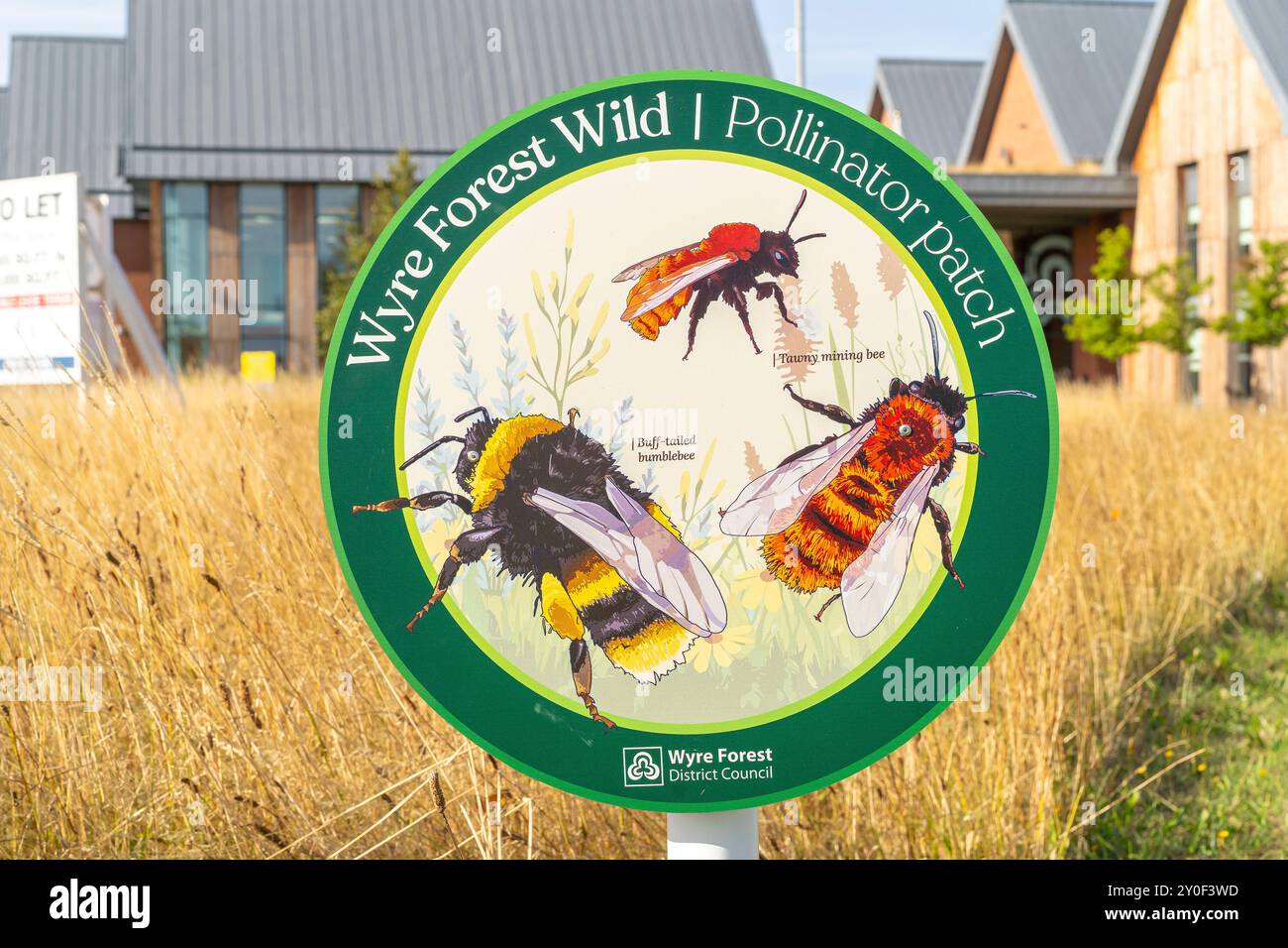 Large circular sign showing a bee pollinator patch outside council ...