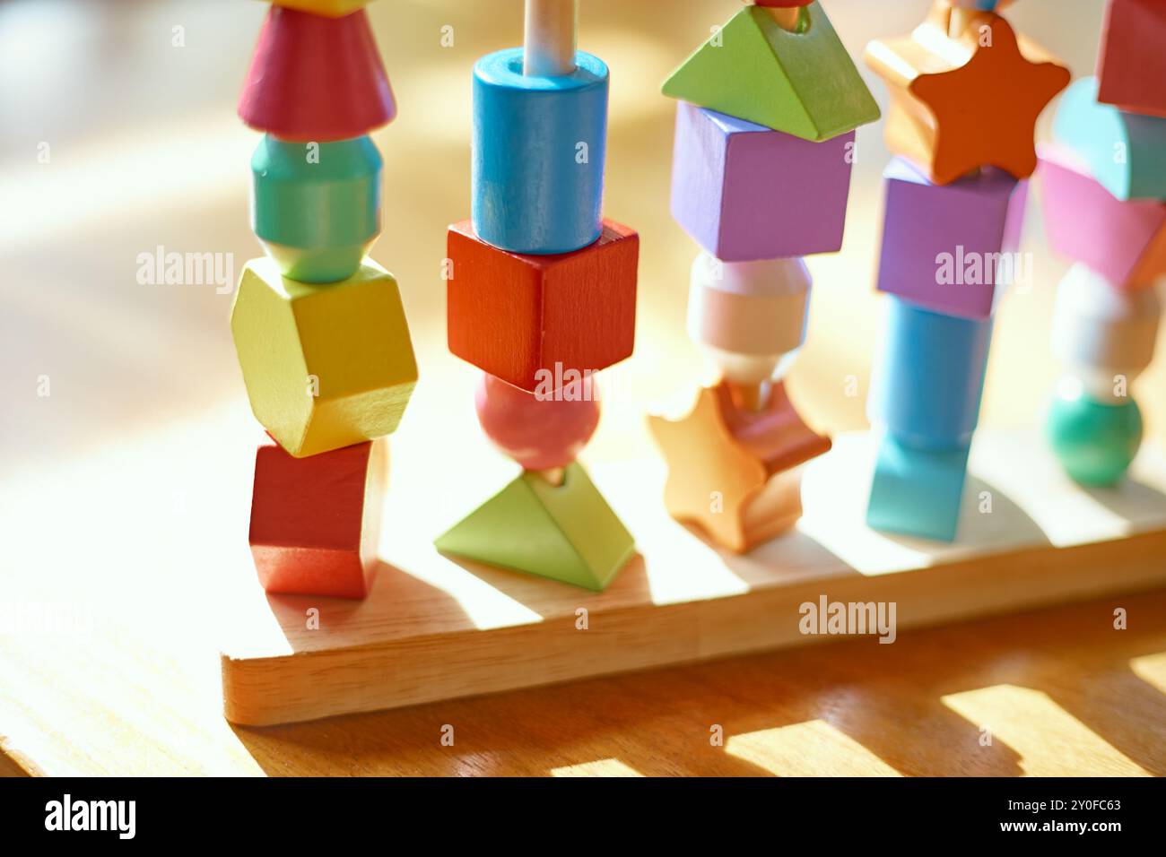 Wooden geometric shapes toy on wood background Stock Photo - Alamy