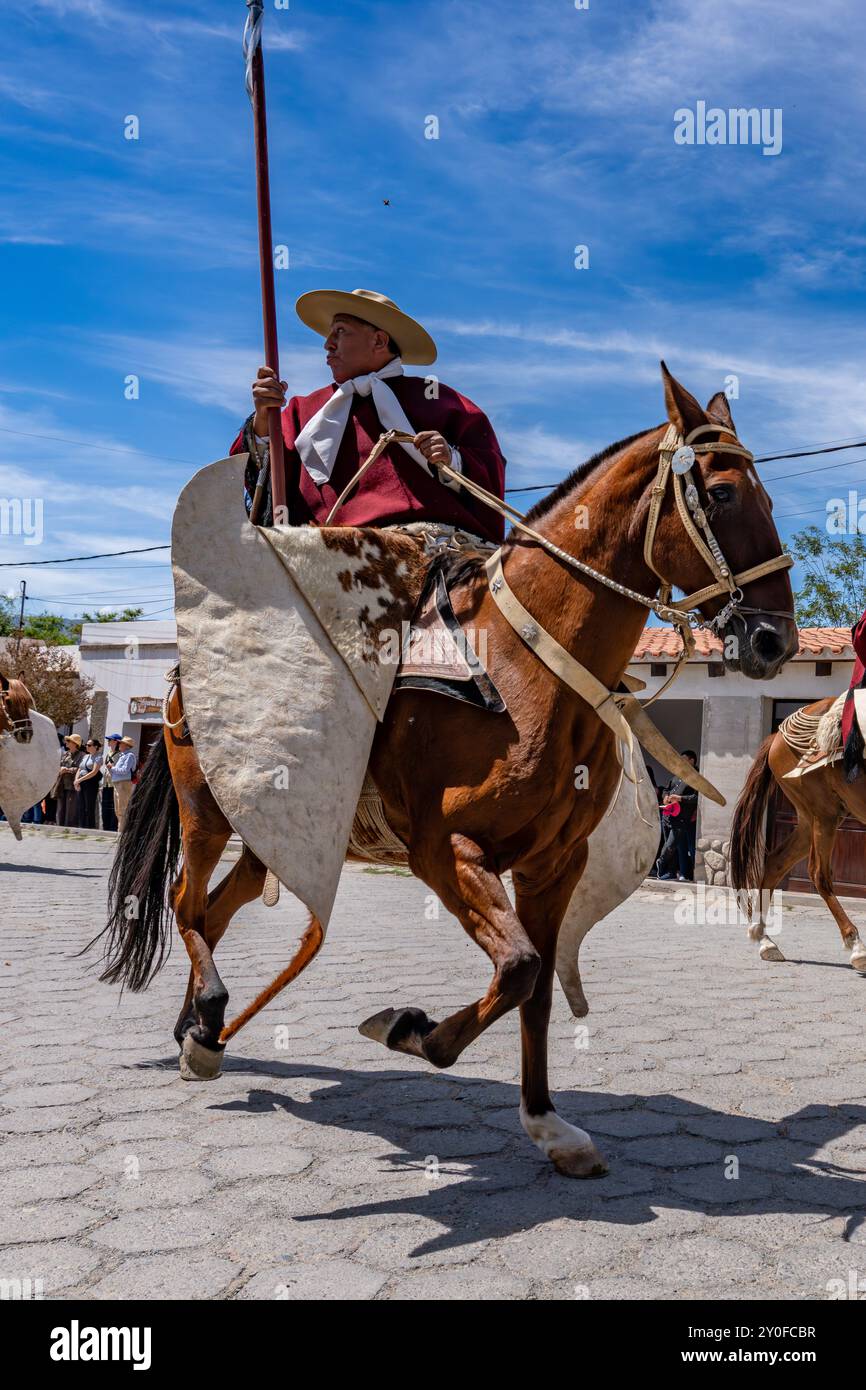 A gaucho in a traditional outfit rides a parade in Cachi, Argentina ...