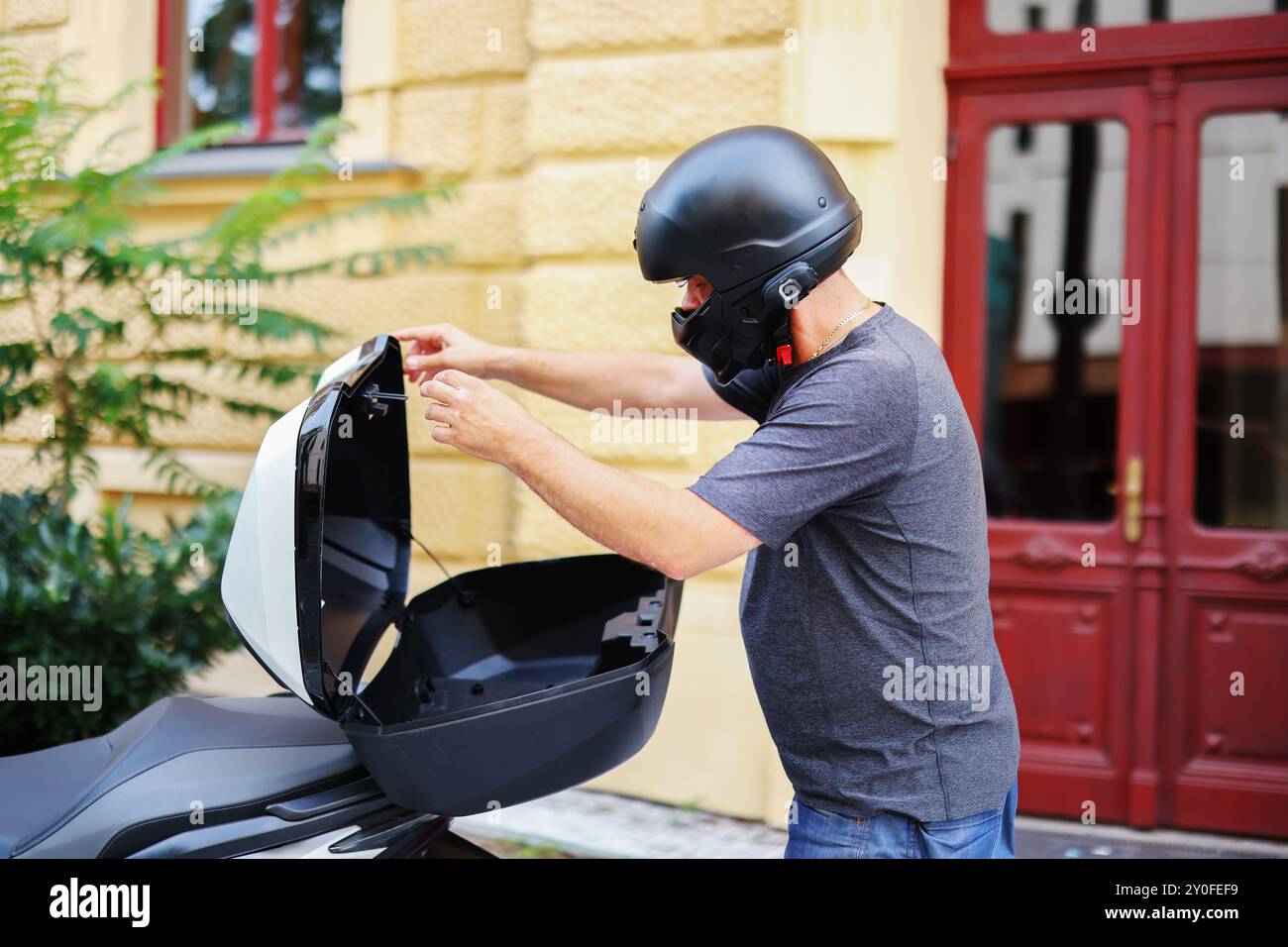 man take helmet from the trunk of a motorcycle. motorcycle safe driving ...