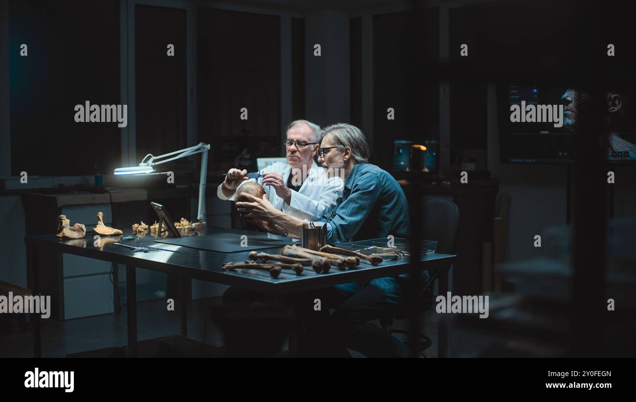 Two archaeologists take measurements of ancient human skull, conduct ...