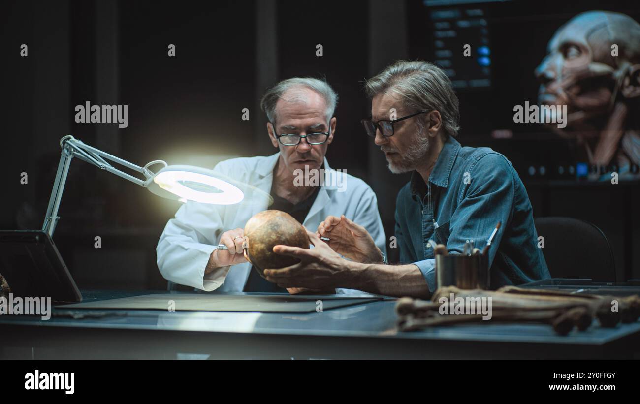 Two archaeologists take measurements of ancient human skull, study ...