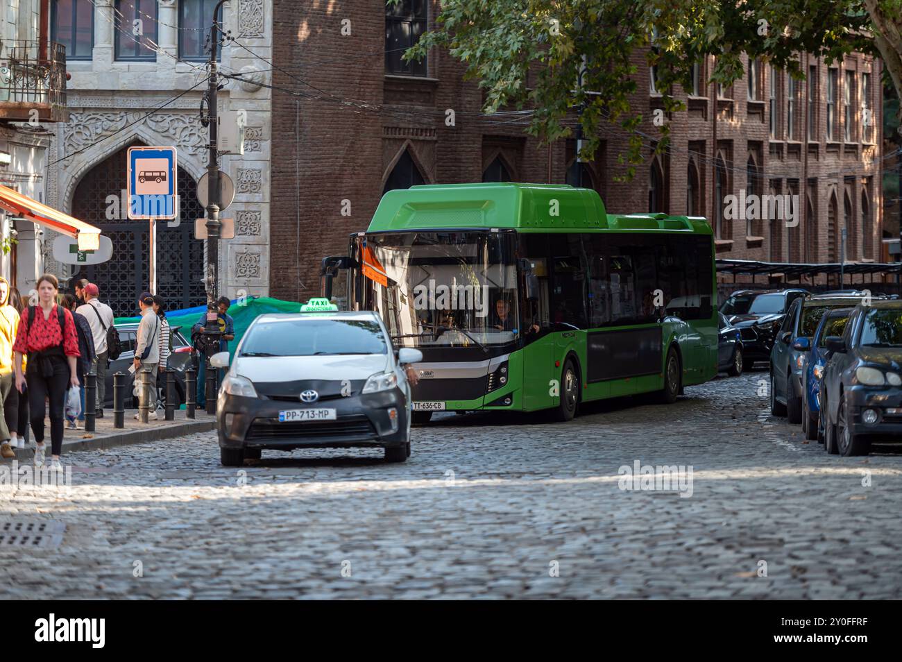 Bus navigates bustling city streets hi-res stock photography and images ...