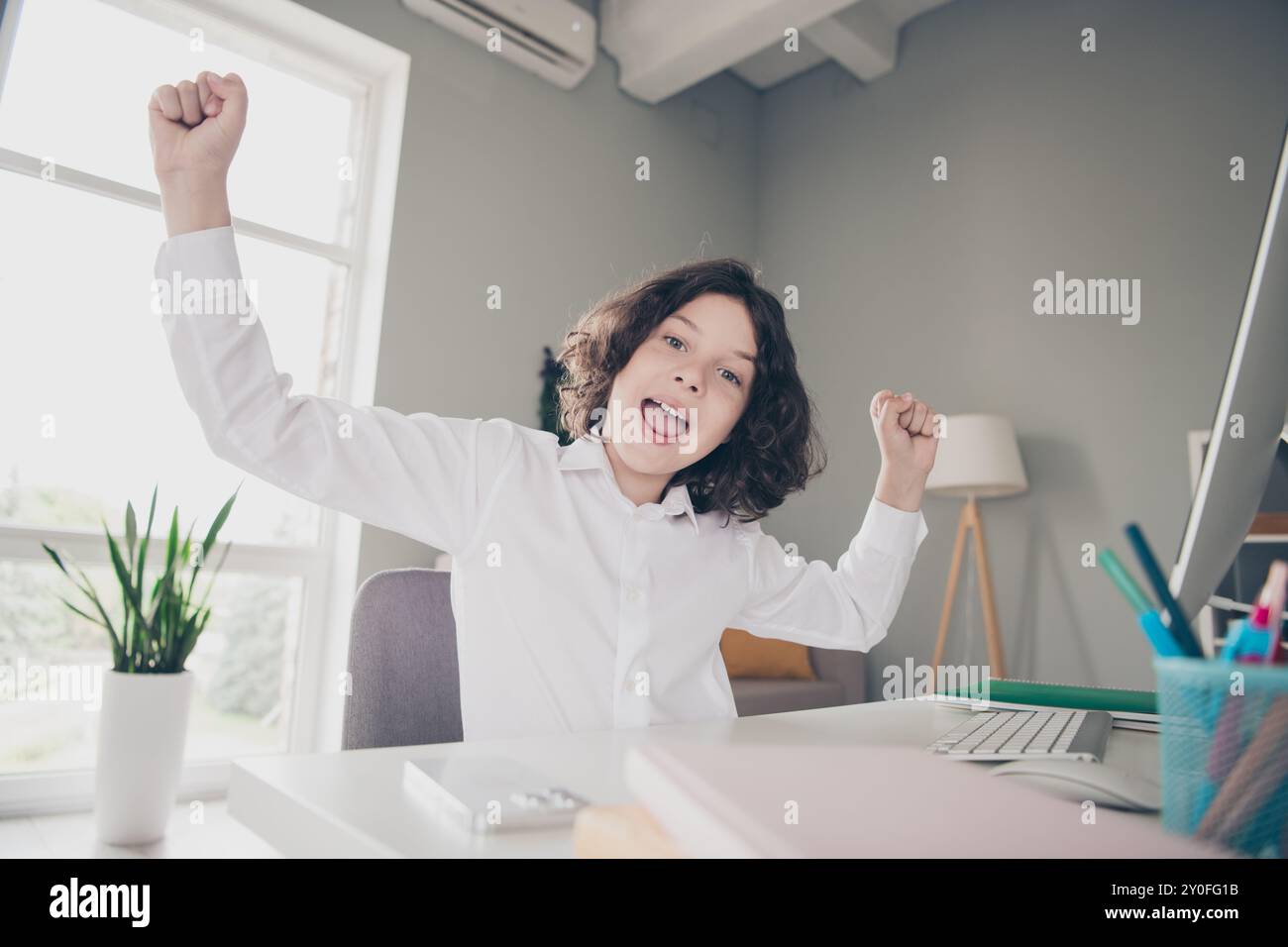 Photo of glad youngster cute boy schoolkid wearing white shirt learning ...