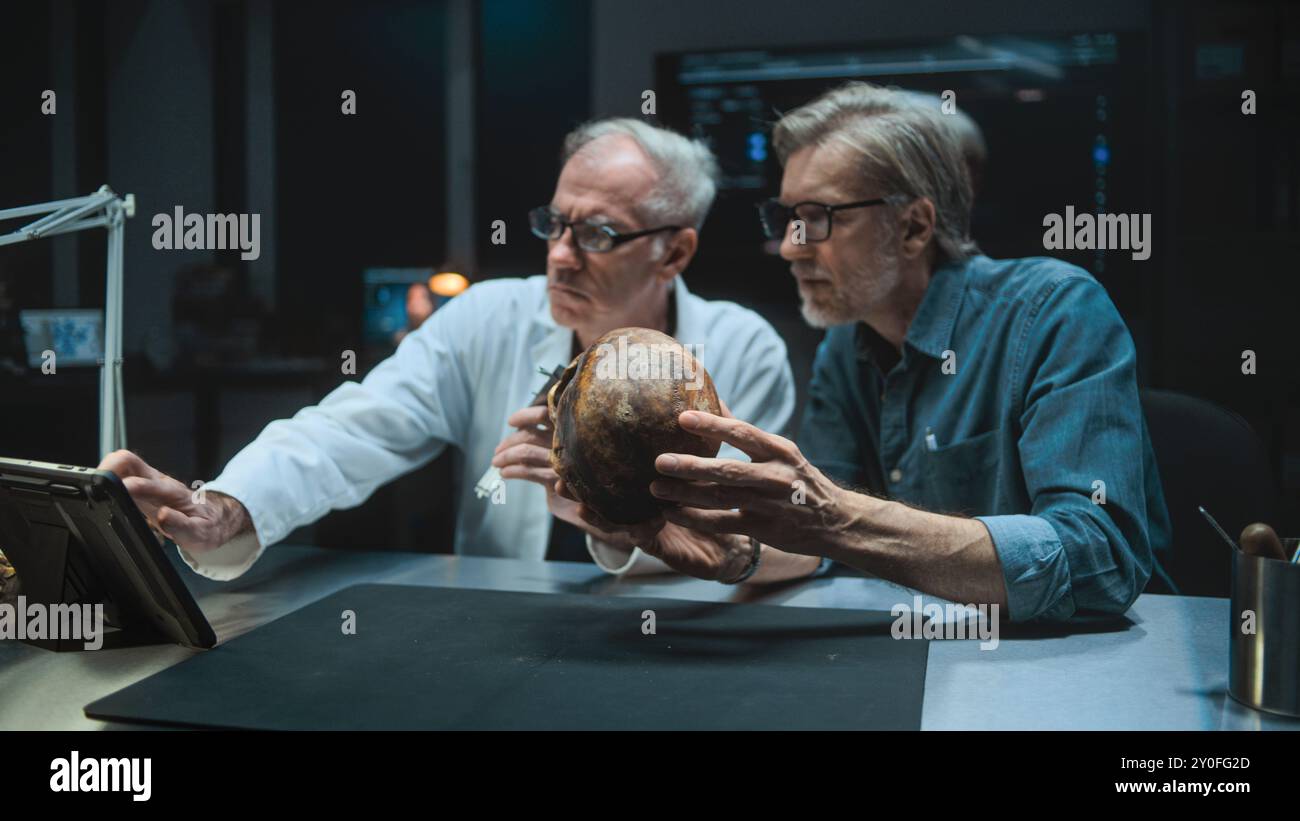 Two archaeologists study fossil hi-res stock photography and images - Alamy