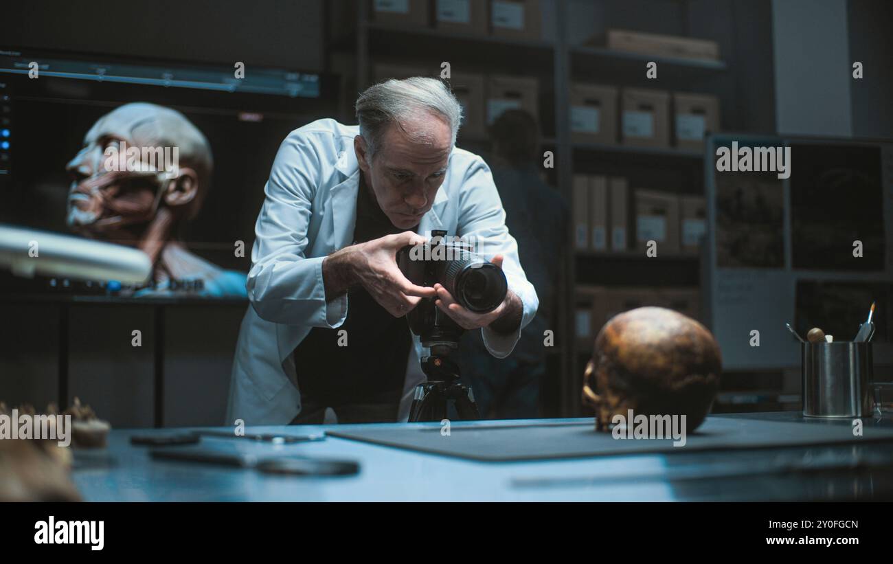 Senior archaeologist takes photo of fossil remains of prehistoric human ...