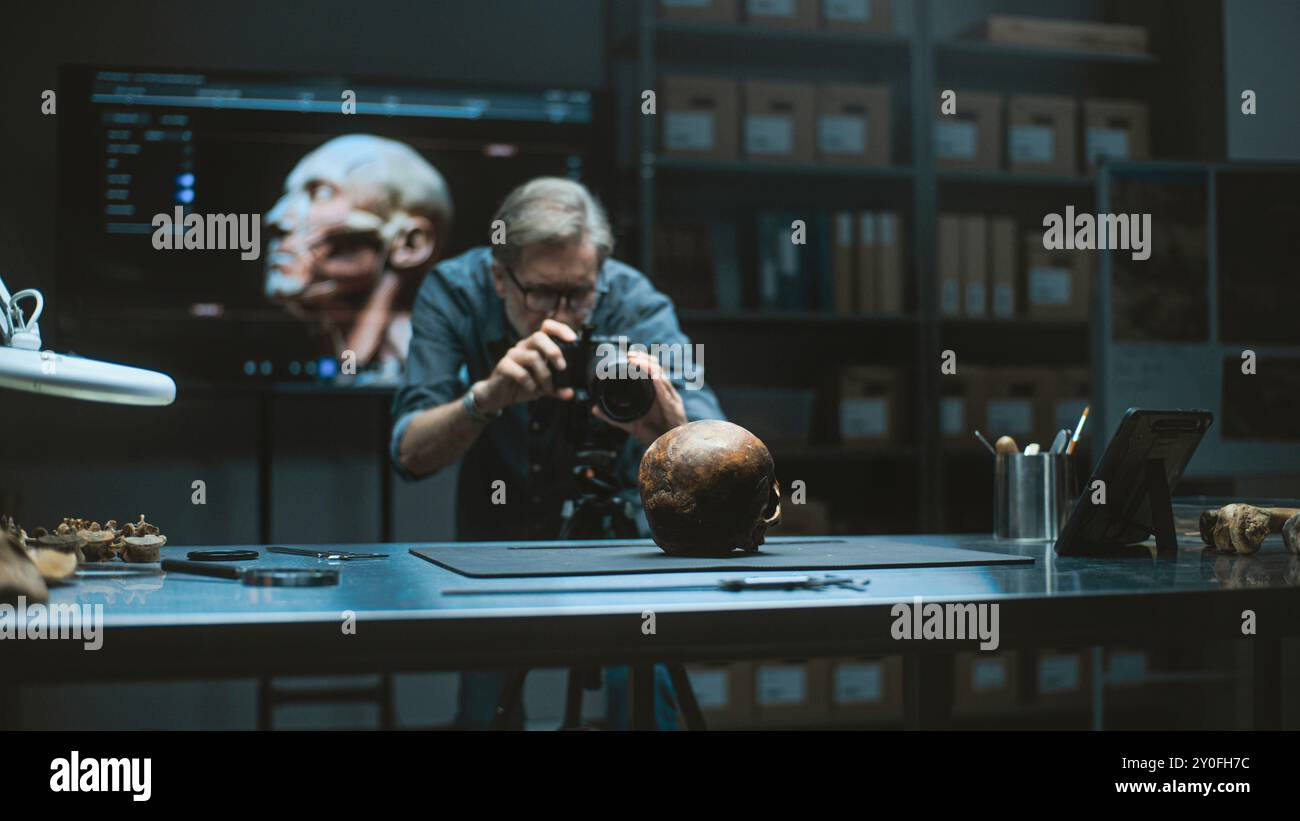 Mature archaeologist takes photo of fossil remains of prehistoric human ...