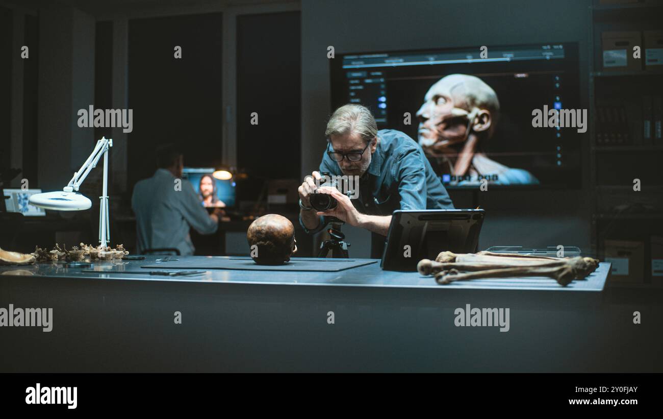 Mature archaeologist photographs fossil skull of ancient human in ...