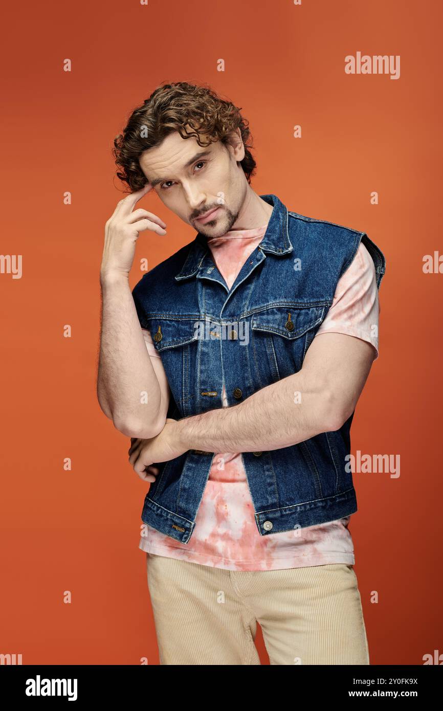 A charming man poses thoughtfully with a vibrant backdrop Stock Photo ...