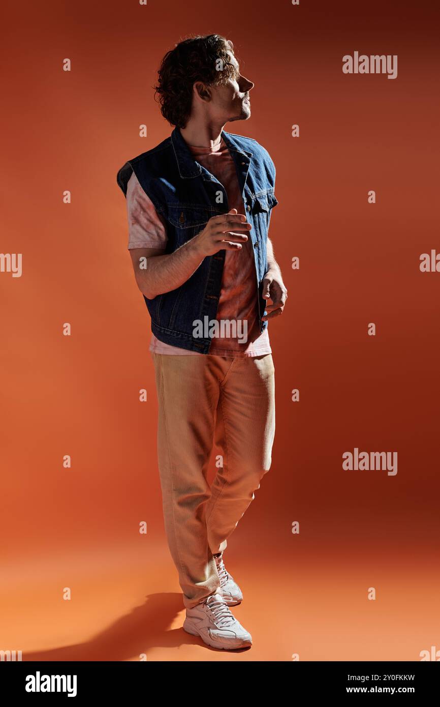 A young man poses thoughtfully, showcasing deep emotion in warm hues ...