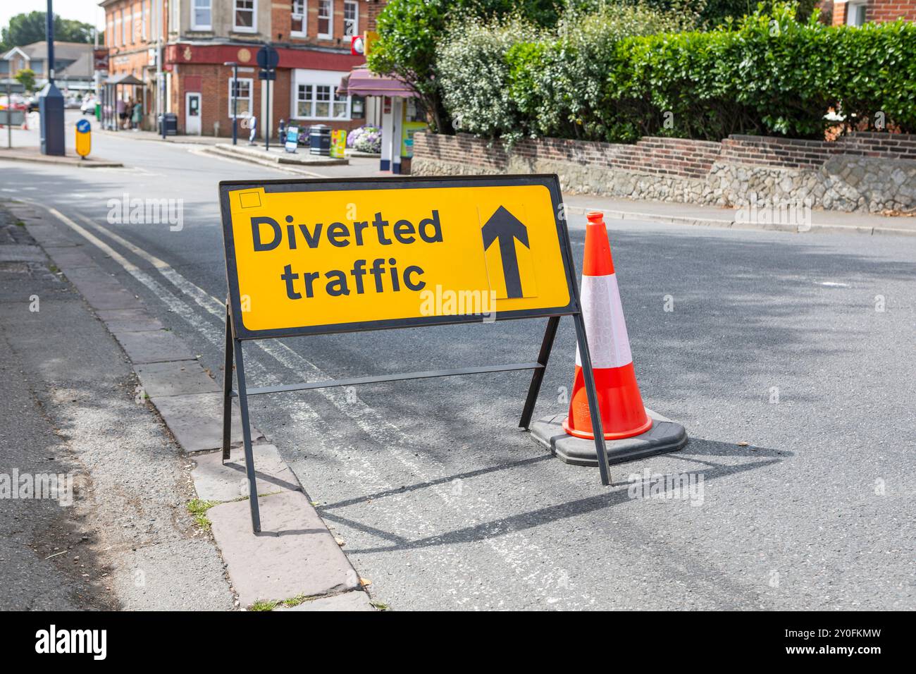 A yellow and black diverted traffic sign Stock Photo - Alamy