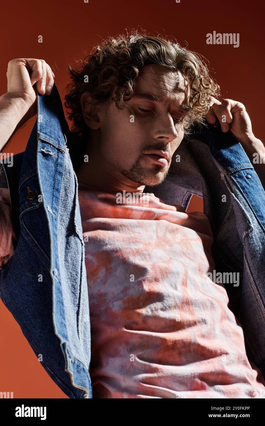 A handsome man showcases his emotional expression with a vibrant ...