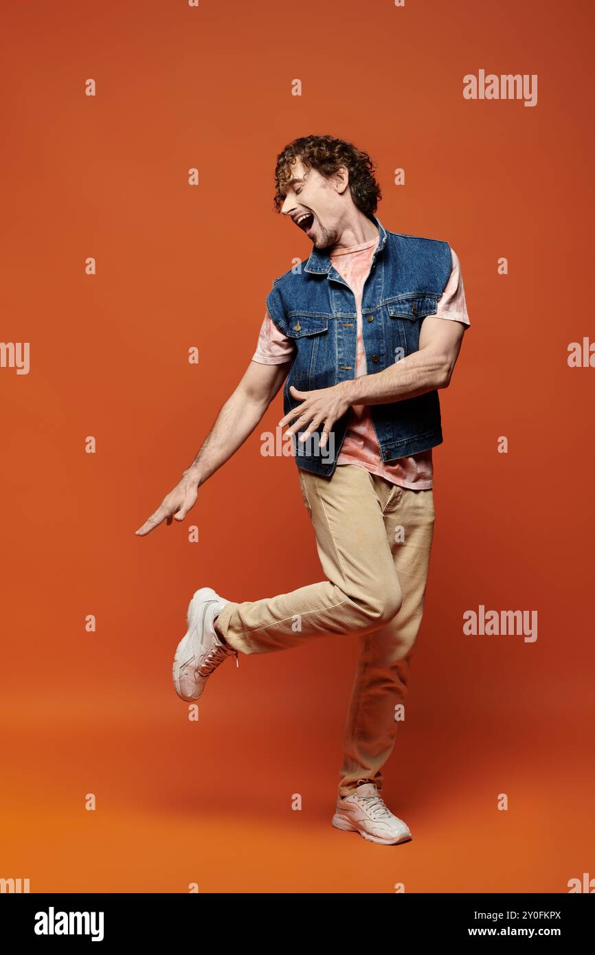 A lively man showcases his emotions with a playful pose on a colorful ...