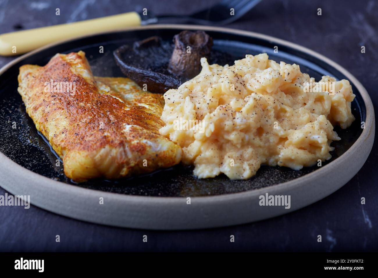 Fish fillet with scrambled eggs and mushroom Stock Photo - Alamy