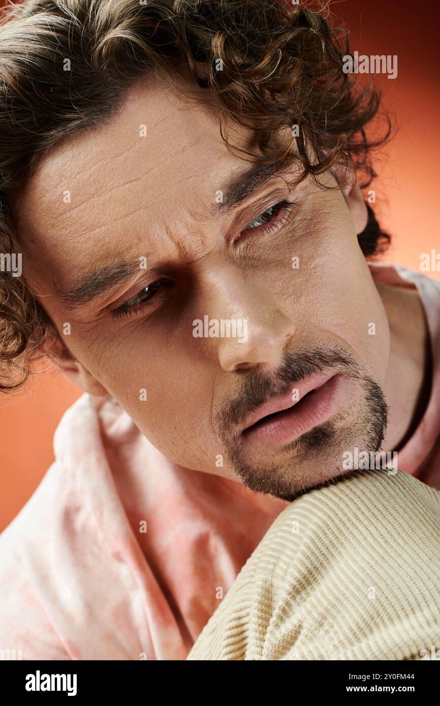 A contemplative man expresses deep emotions in a striking setting Stock ...