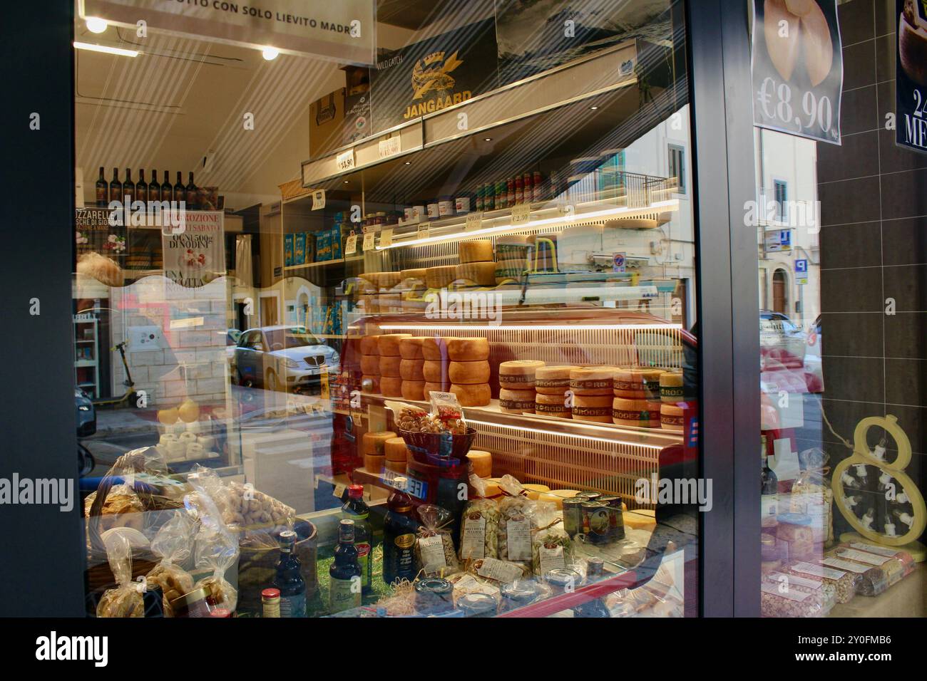 deli window display in monopoles italy with cheese olive oil wine etc ...