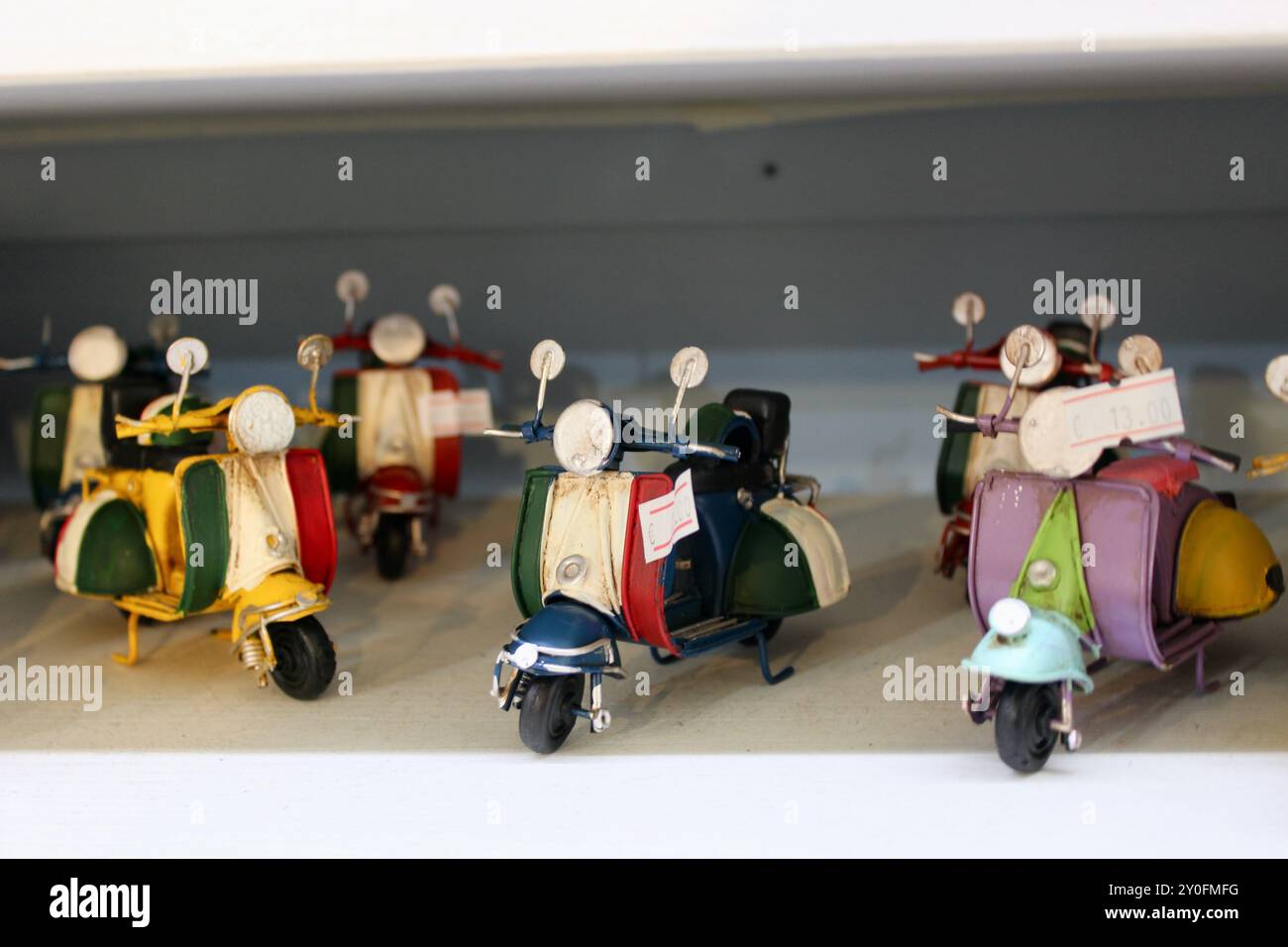 small model vespas for sale to tourists; various vespa scooters parked ...