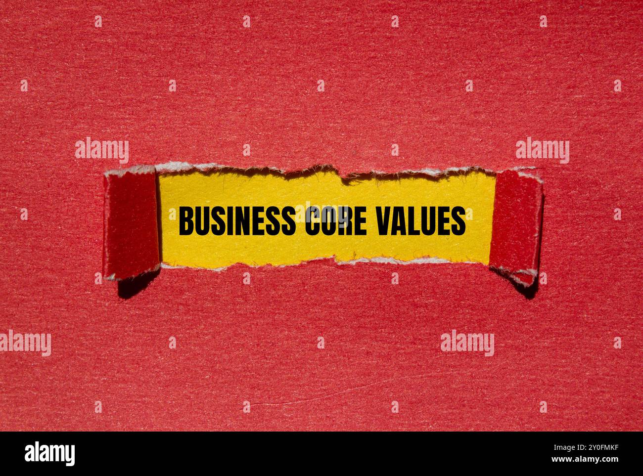 Business core values message written on ripped torn red paper with ...