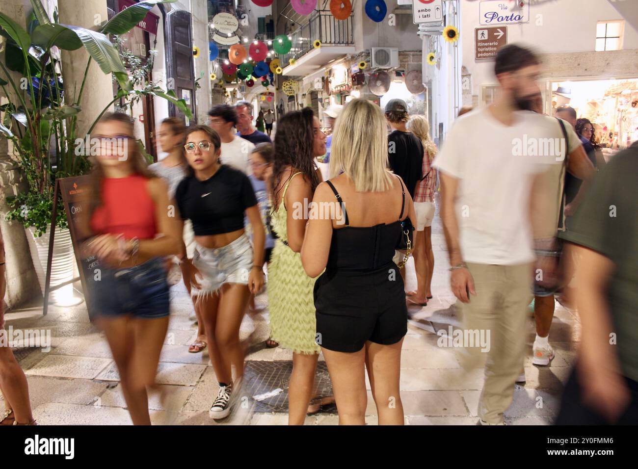 young people in the streets at evening; the colourful streets and ...