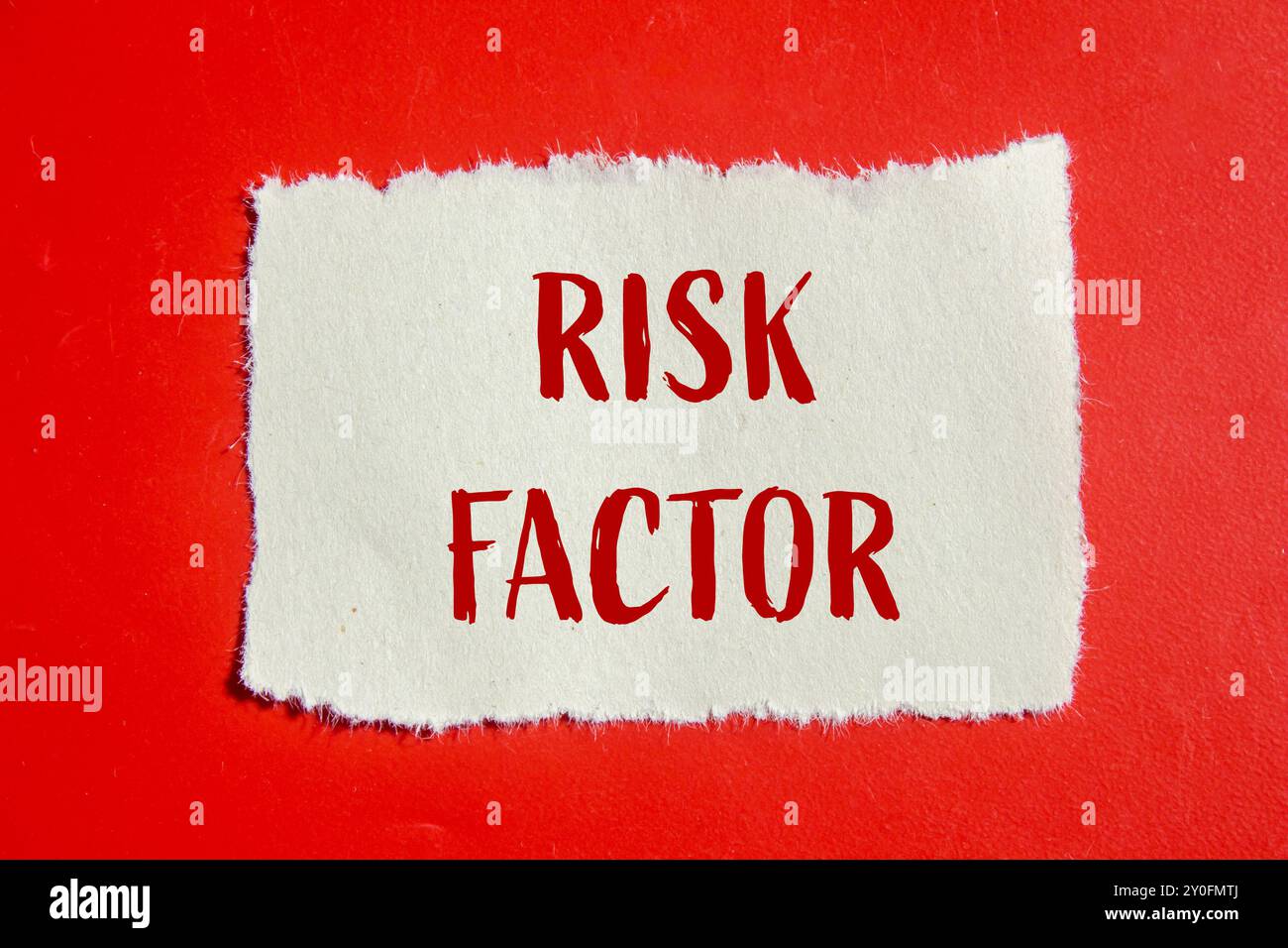 Risk factor message written on ripped torn paper piece with red ...