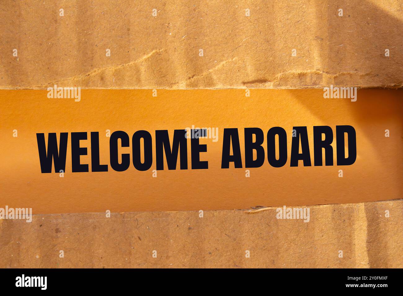 Welcome aboard message written on ripped torn cardboard paper with ...