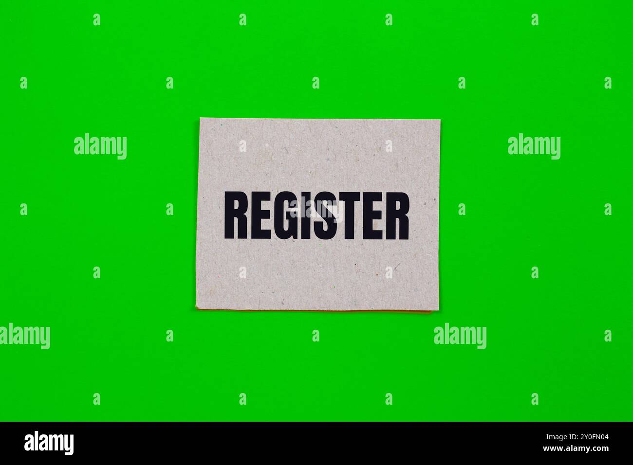 Register message written on paper piece with green background ...