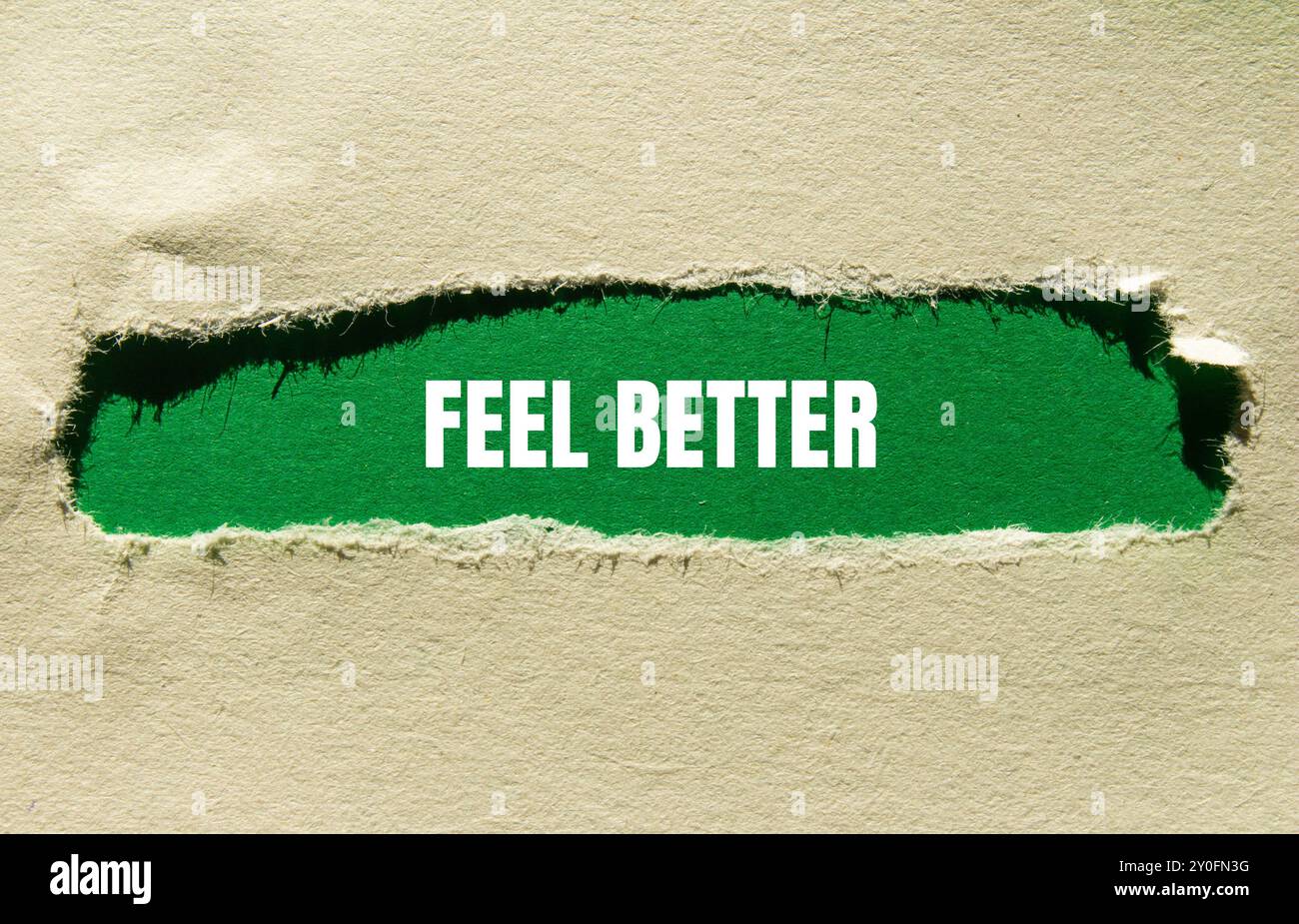 Feel better message written on ripped torn paper with green background ...