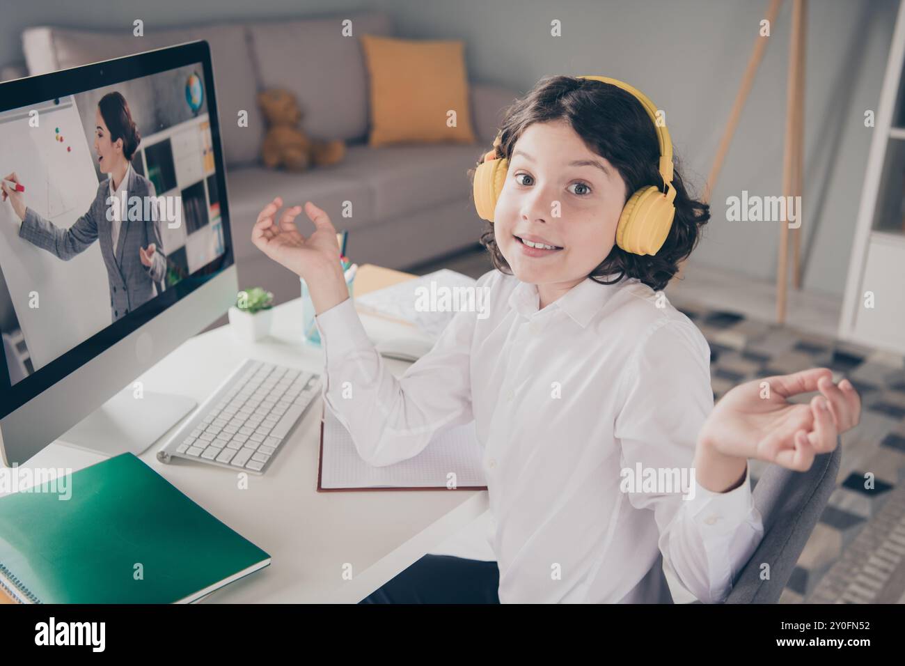 Photo of funny cute little boy schoolkid sitting desk no answer oops ...
