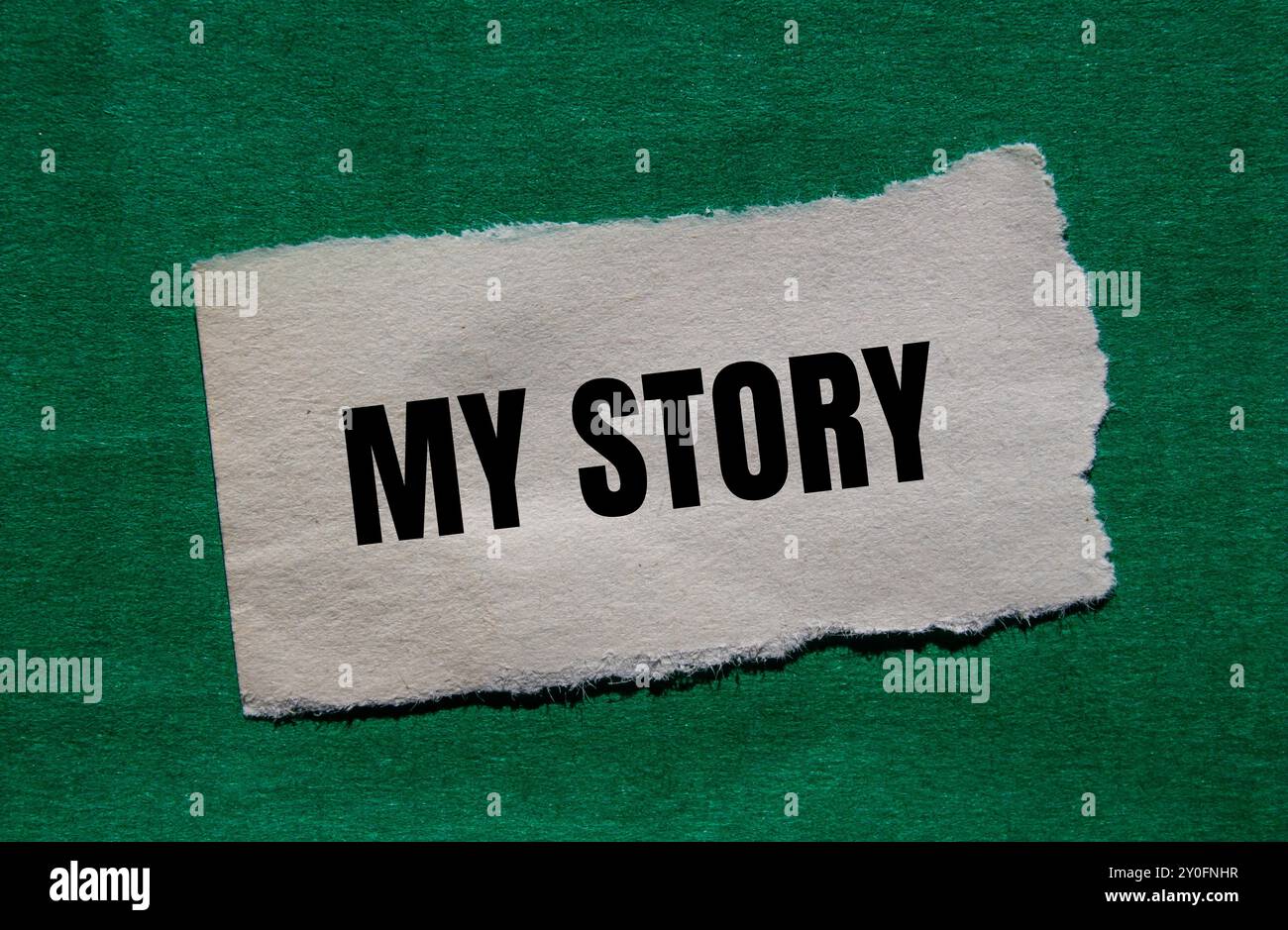 My story message written on ripped torn paper piece with green background. Conceptual my story ...