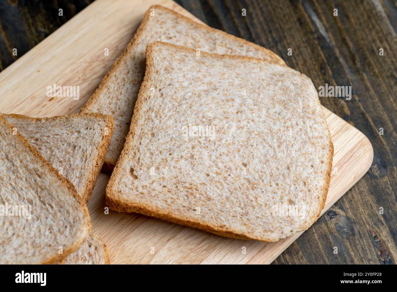 Square loaf of light wheat bread cut into pieces, sliced wheat bread ...