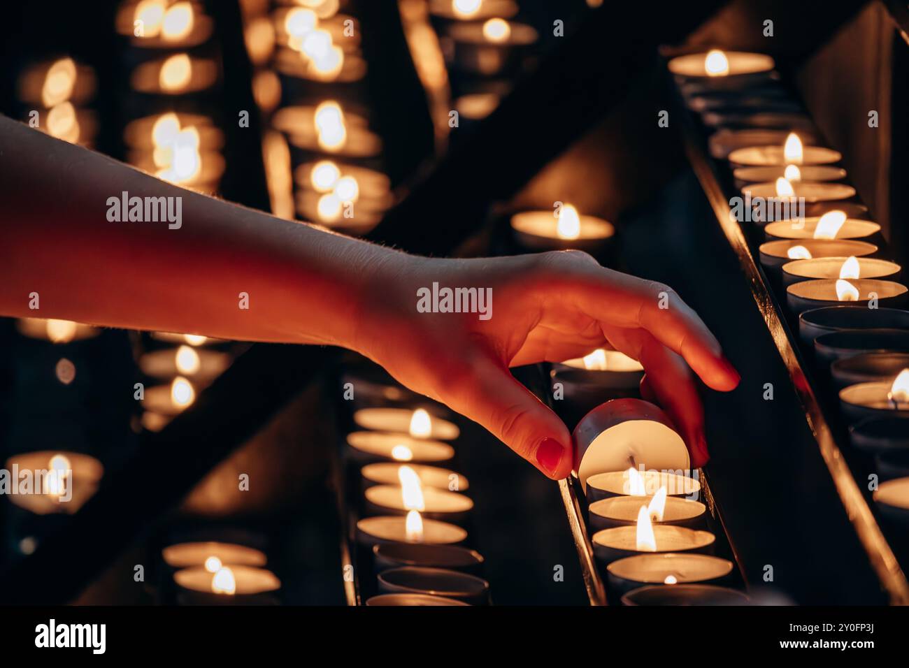 Serene hand lighting candle hi-res stock photography and images - Alamy