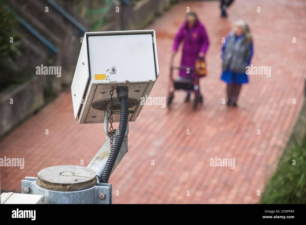 Surveillance camera with walking elderly people in the background in ...