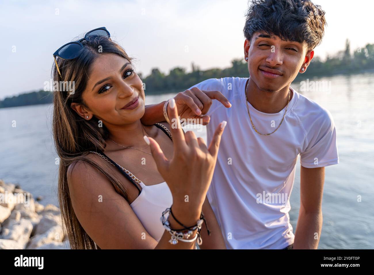 beautiful young couple of teenagers having fun making funny faces on ...