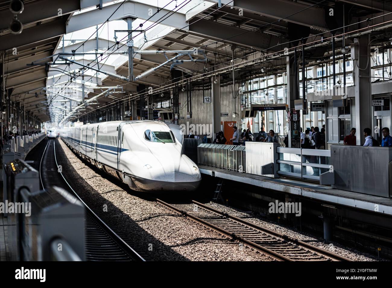 KYOTO, JAPAN - MAY 13, 2019: A Shinkansen high-speed bullet train pulling into a train station ...