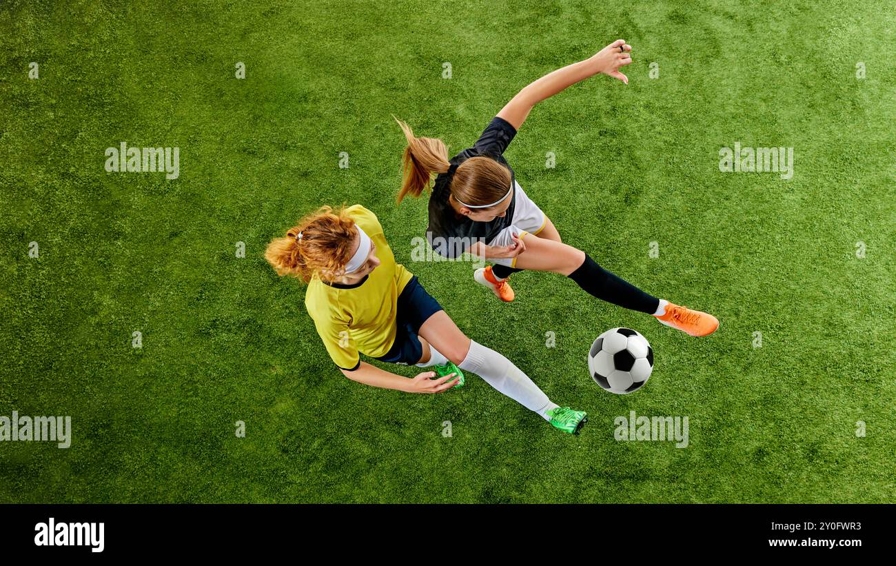 Two athletic women, locked in fierce duel over ball, showcasing agility ...