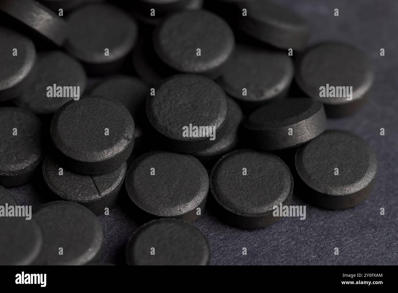 Open and unpacked tablets of black color close-up, several of the same ...