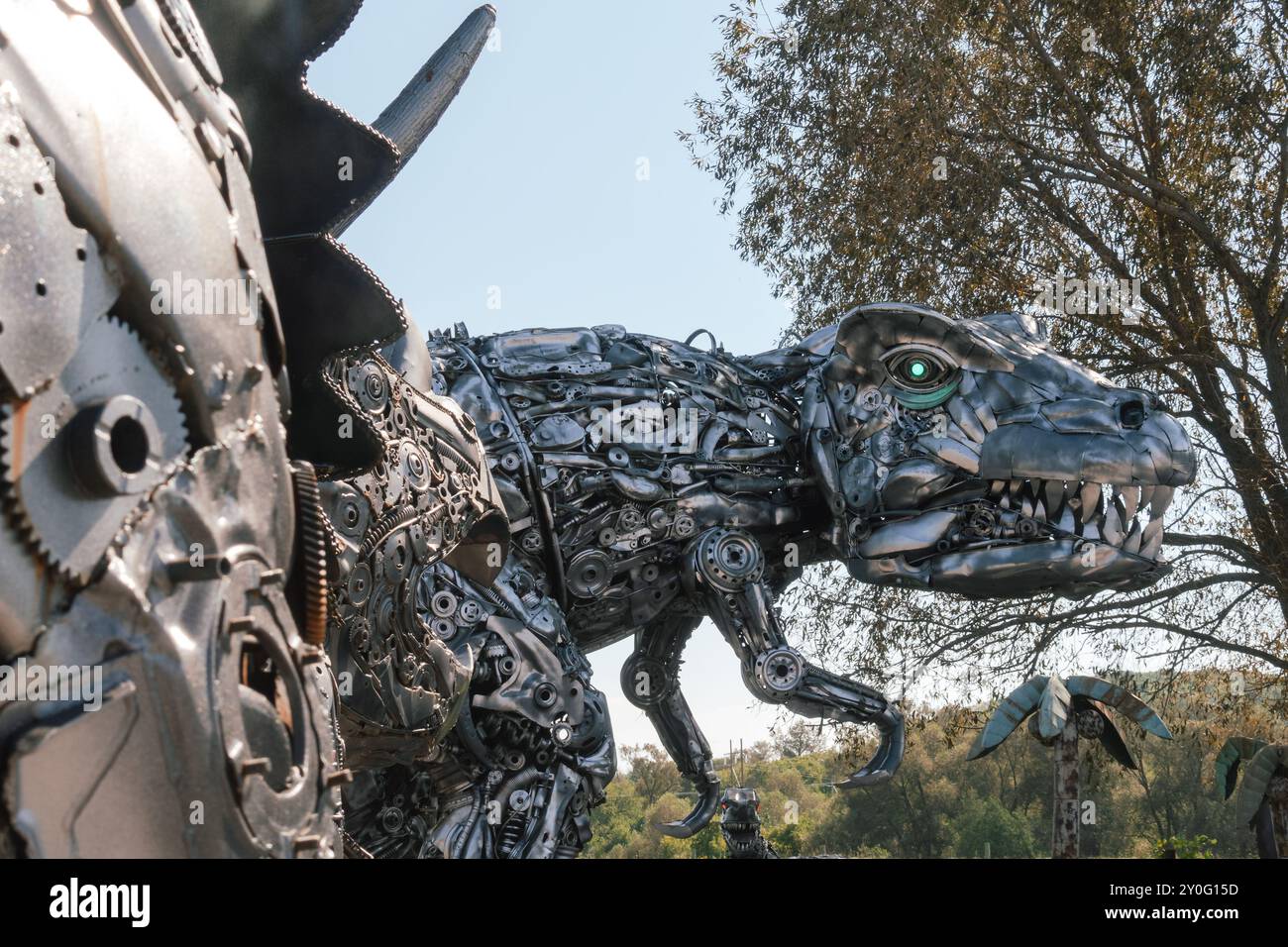 A large metal dinosaur sculpture, featuring intricate details and a ...