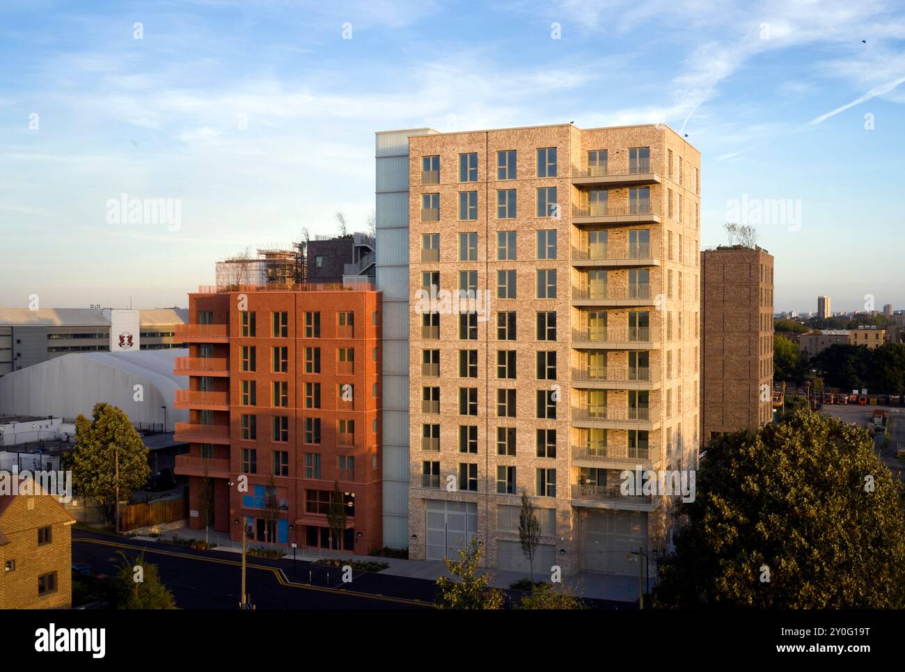 Sunlit brick facades of apartment blocks. Osier Way, London, United ...